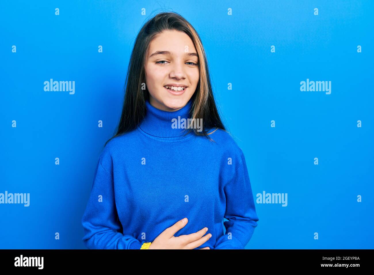 Young brunette girl wearing turtleneck sweater smiling and laughing ...