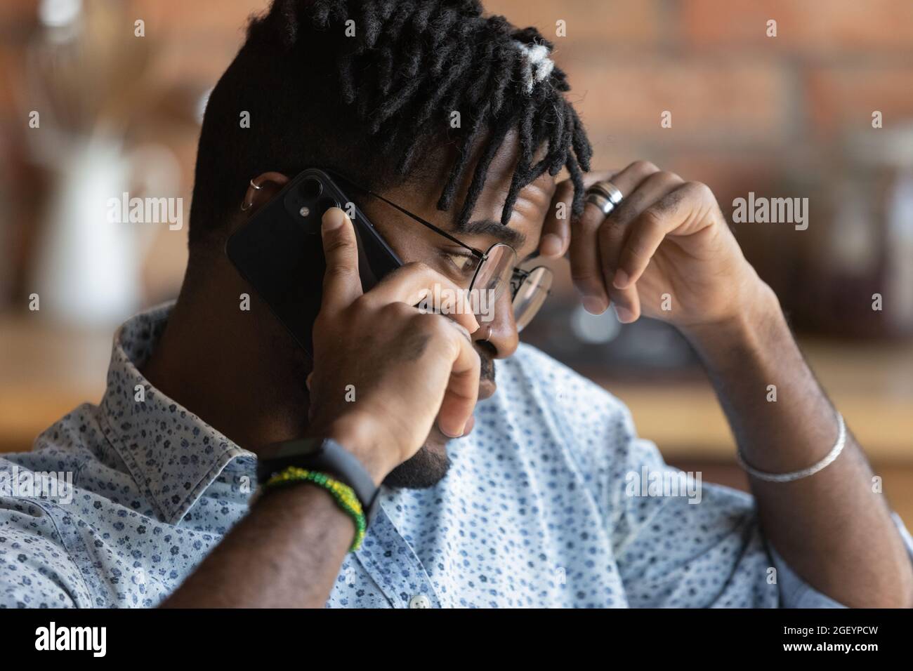 Thoughtful concerned millennial African guy making telephone call Stock ...