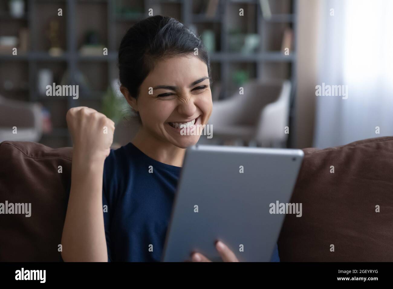 Excited Indian woman triumph with good news on cell Stock Photo - Alamy