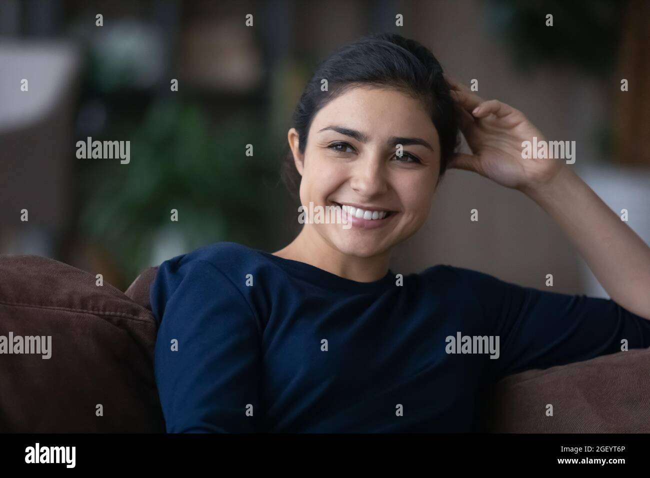 Smiling Indian woman look in distance dreaming Stock Photo - Alamy