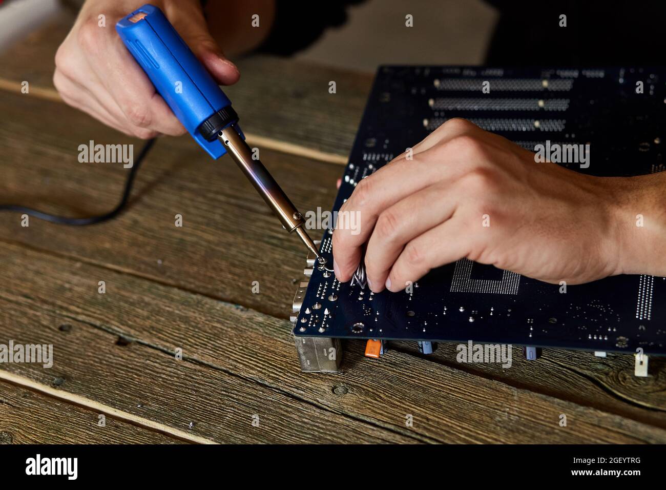 Engineer or technician repair electronic circuit board with soldering ...