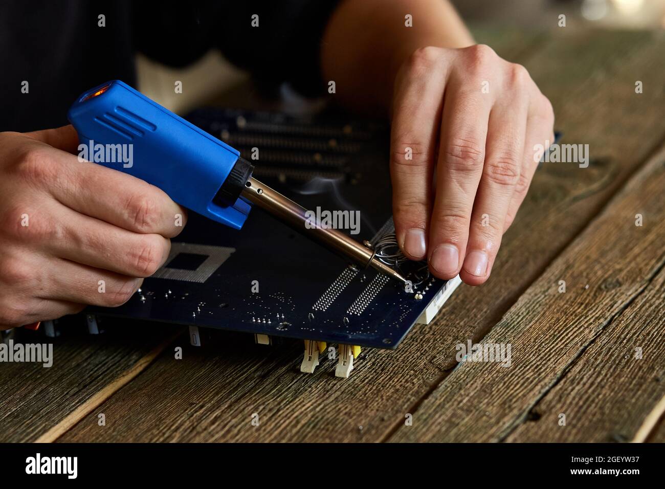 Engineer or technician repair electronic circuit board with soldering ...