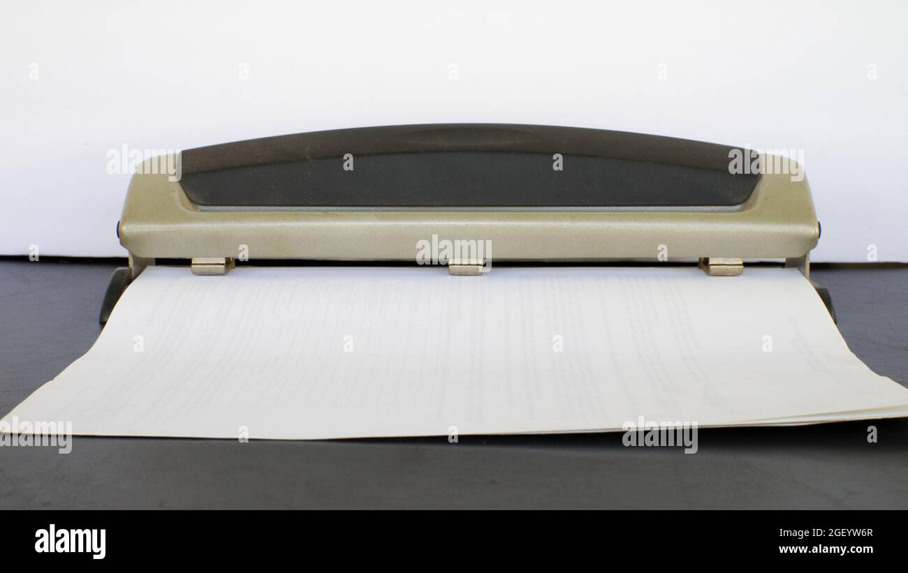 A Three Hole Paper Punch and Paper Stock Photo - Alamy