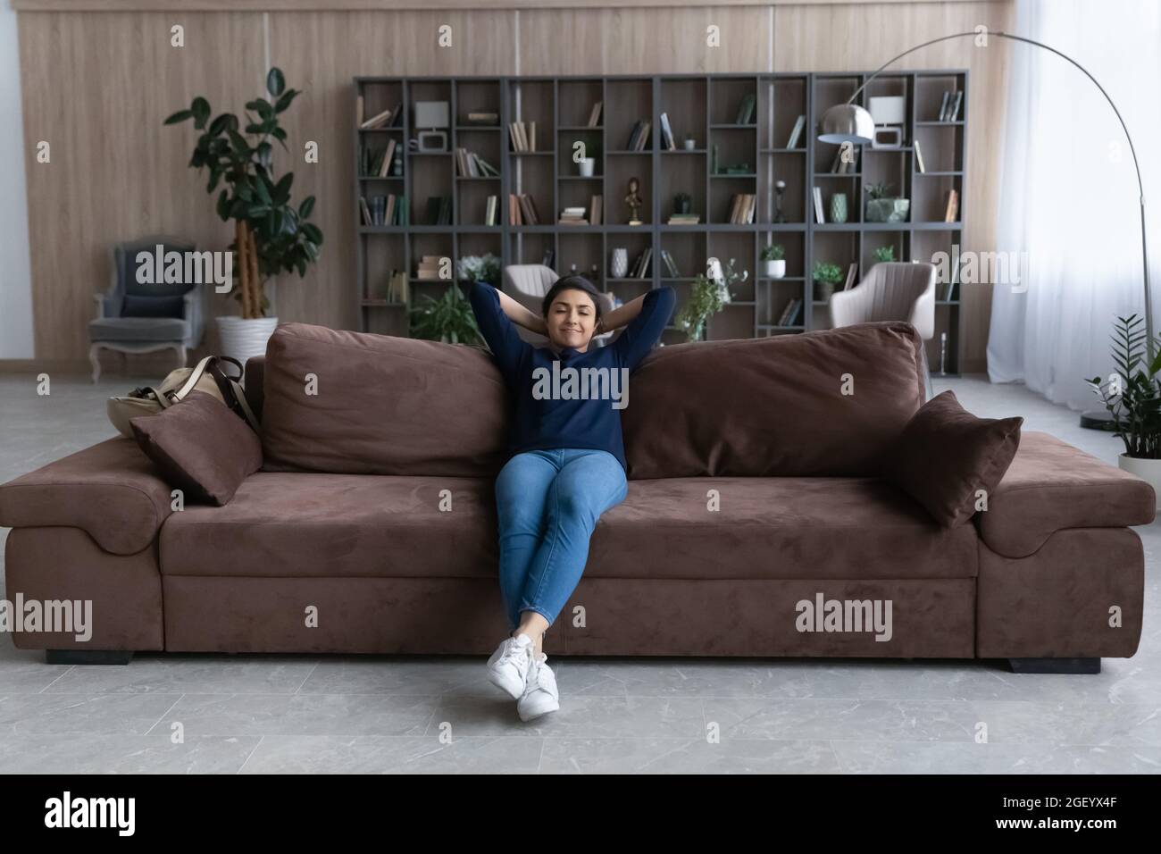 Calm Indian woman relax on sofa breathe fresh air Stock Photo - Alamy