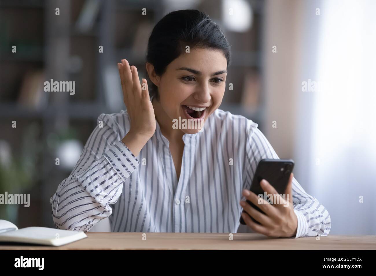 Excited Indian woman shocked by good online deal Stock Photo - Alamy