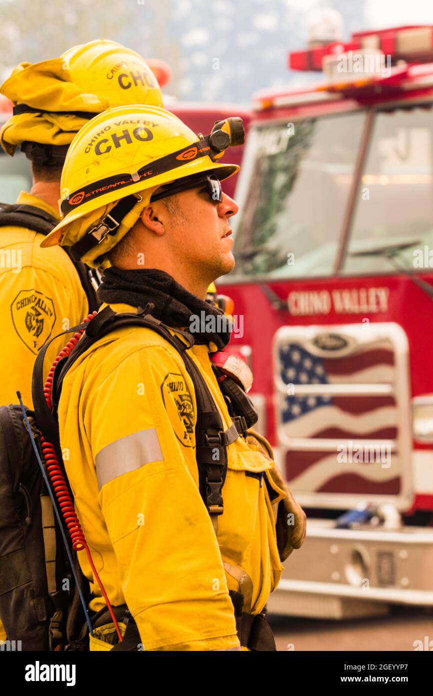 Firefighters monitor a residential area in heavy smoke. The Dixie fire ...