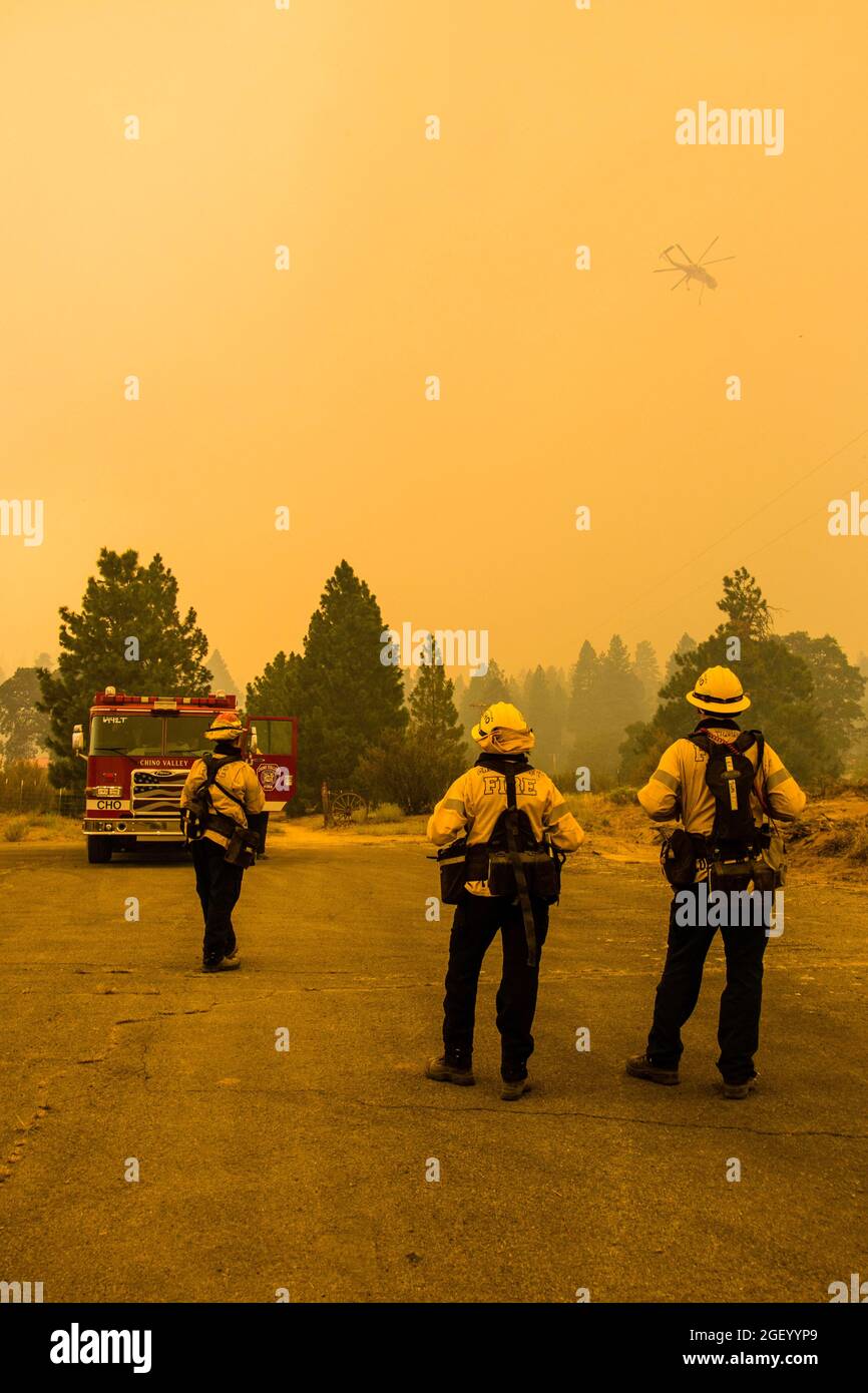 Firefighters watch airdrops on the Dixie fire. The Dixie fire continues ...