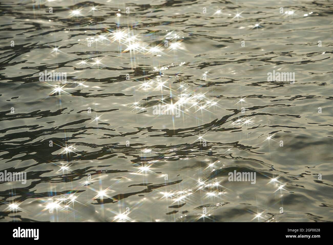 Detail of a sunlight reflecting in glittering sea. sparkler in water ...