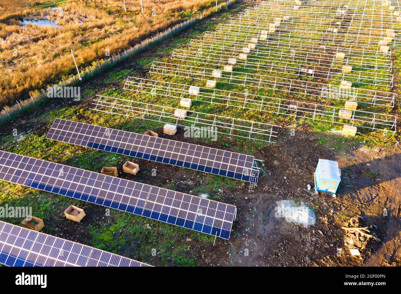 Aerial view of solar power plant under construction on green field ...