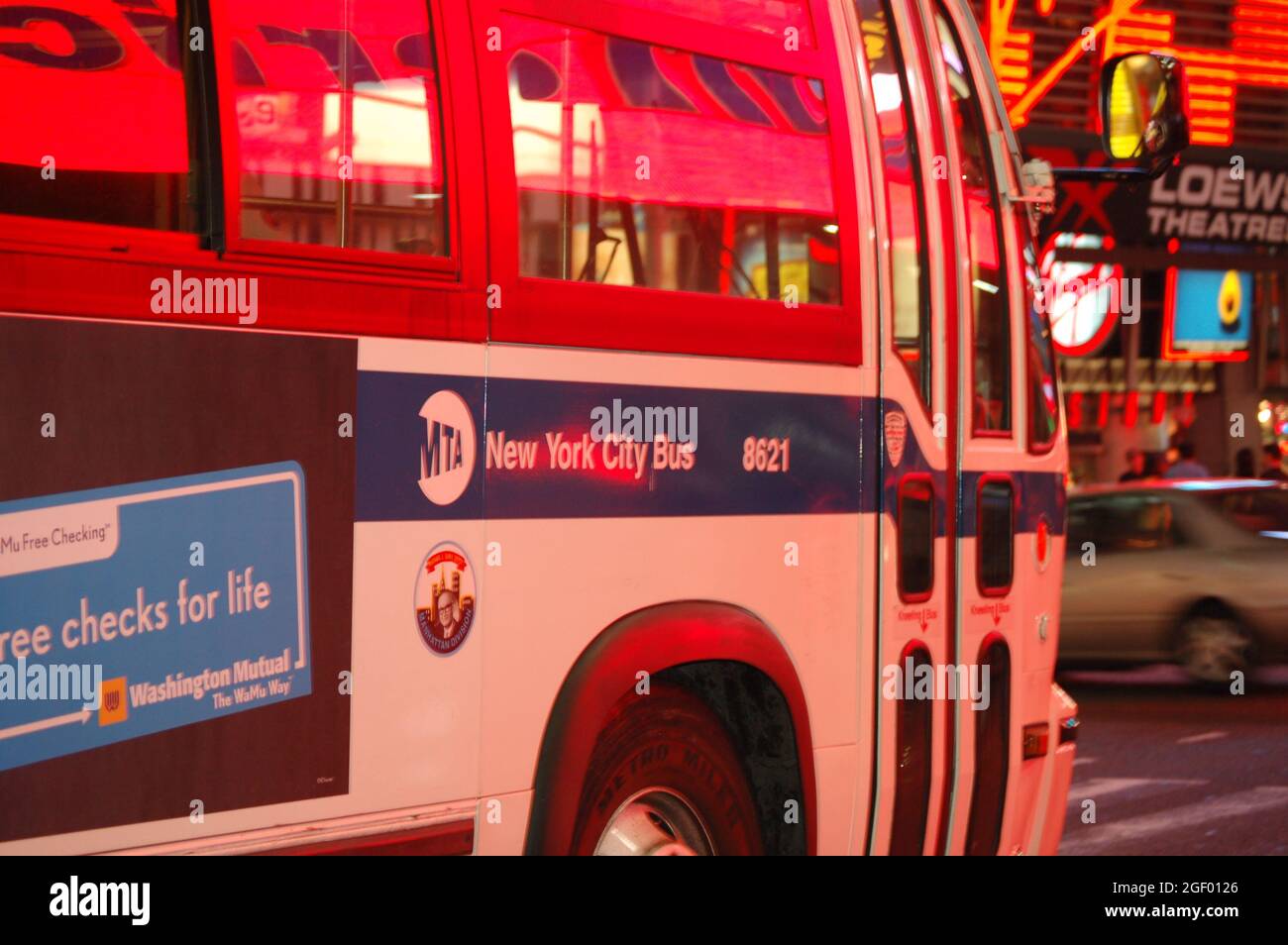 New York City Bus reflecting neon advertising in Times Square, New York ...