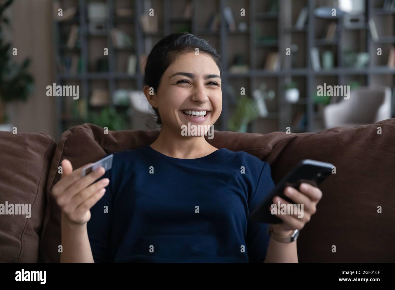 Smiling Indian woman shopping on cellphone with card Stock Photo - Alamy