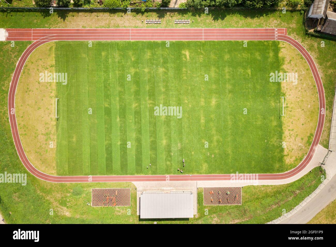 Aerial view of sports stadium with red running tracks and green grass ...