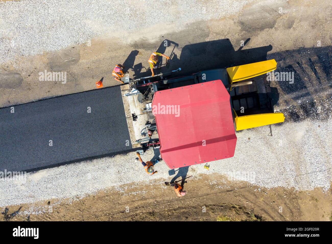 Aerial view of new road construction with asphalt laying machinery at ...