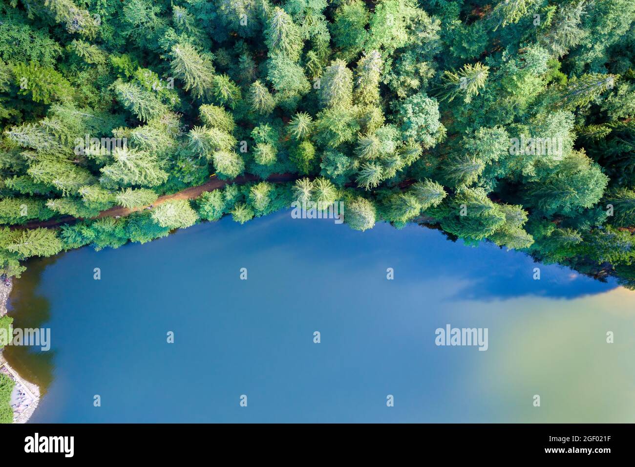 Top down aerial view of big lake with clear blue water between high ...