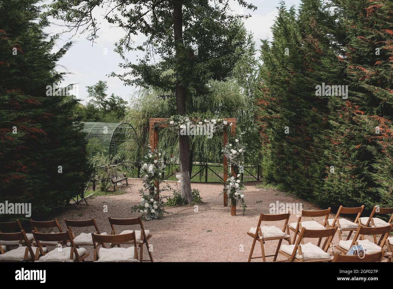 Rustic wedding arch for an ceremony decorated with white and flowers ...