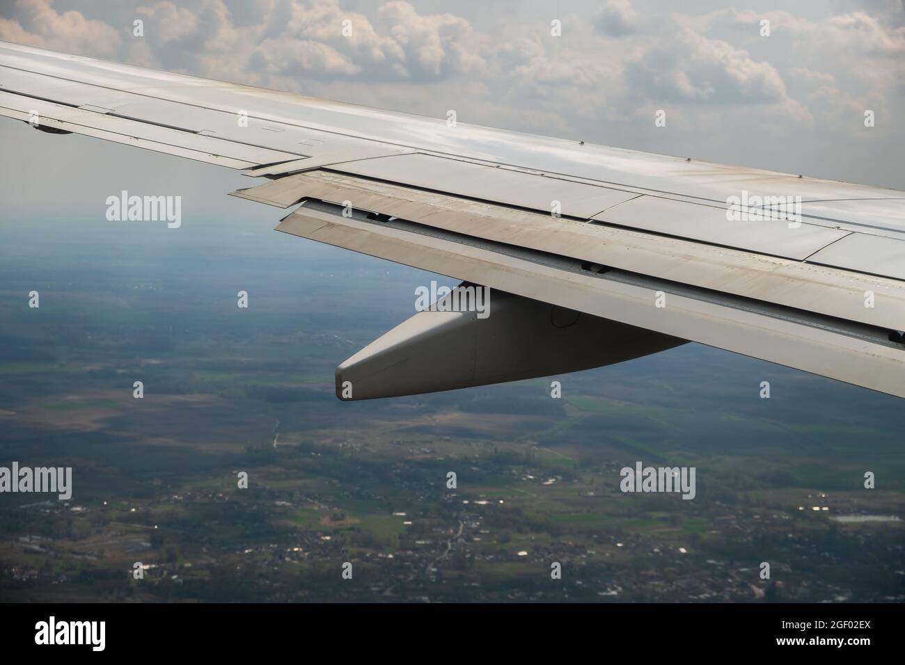 View of jet airplane wing landing at airport in bad weather. Travel and ...