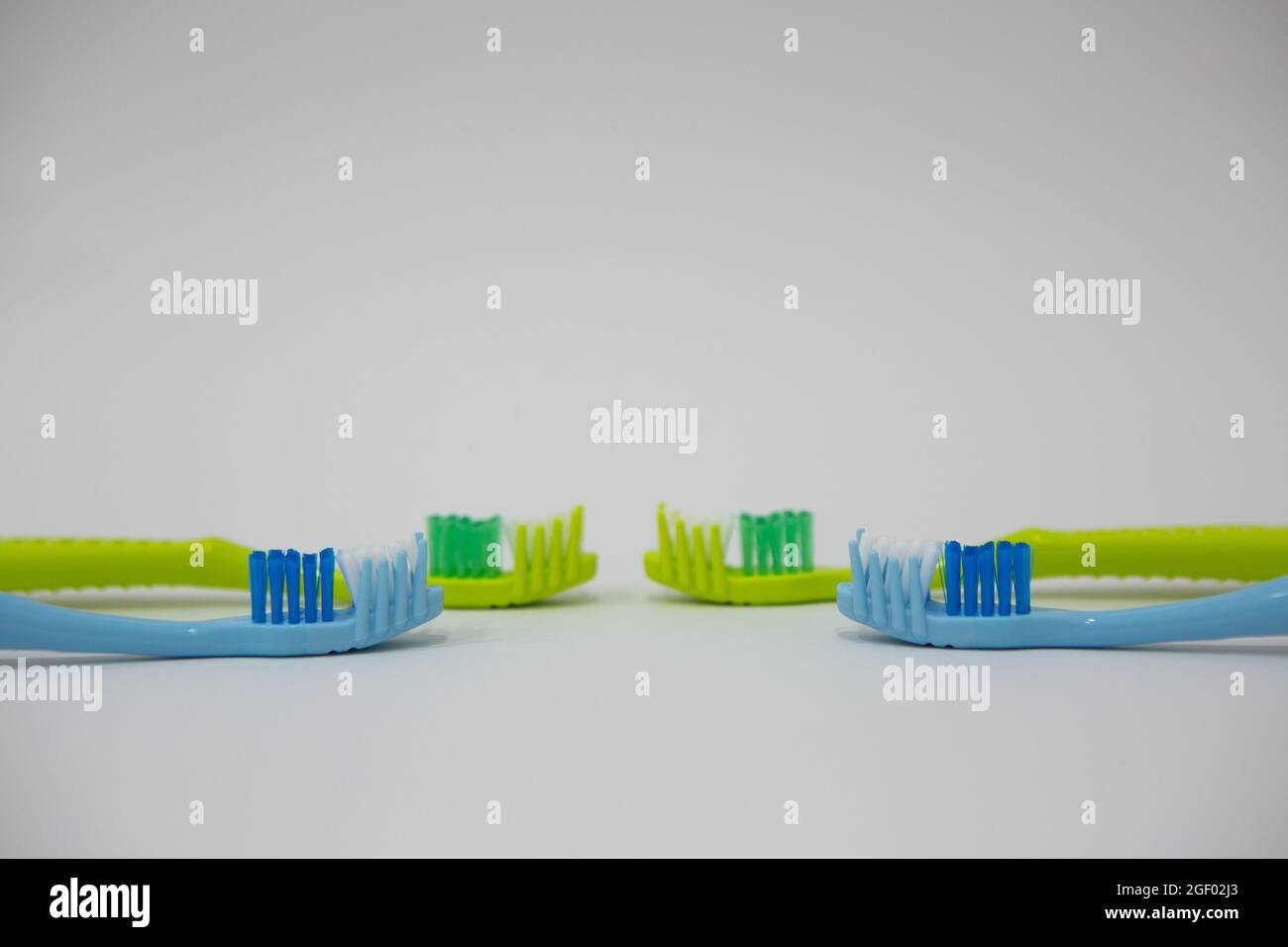 Blue toothbrushes on a white background. Protecting teeth from caries ...