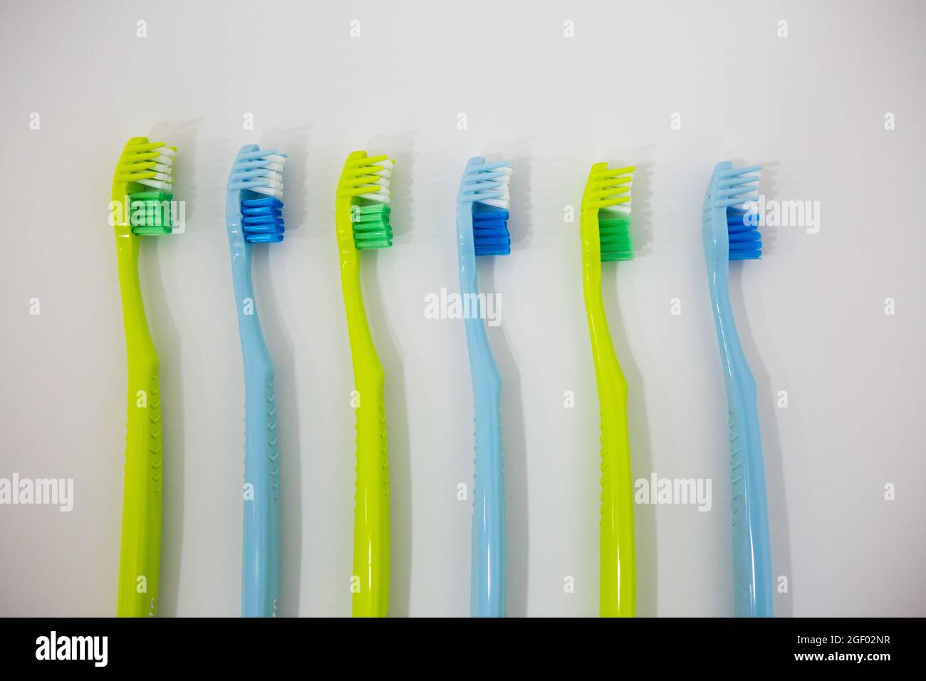 Blue toothbrushes on a white background. Protecting teeth from caries ...