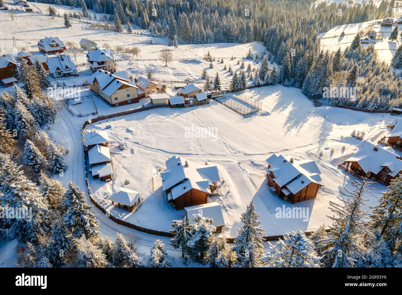 Aerial winter landscape with small village houses between snow covered ...