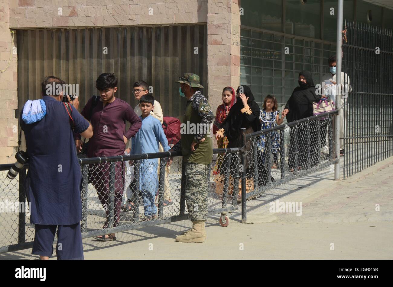 Taliban fighters stand guard on their side at a border crossing point ...