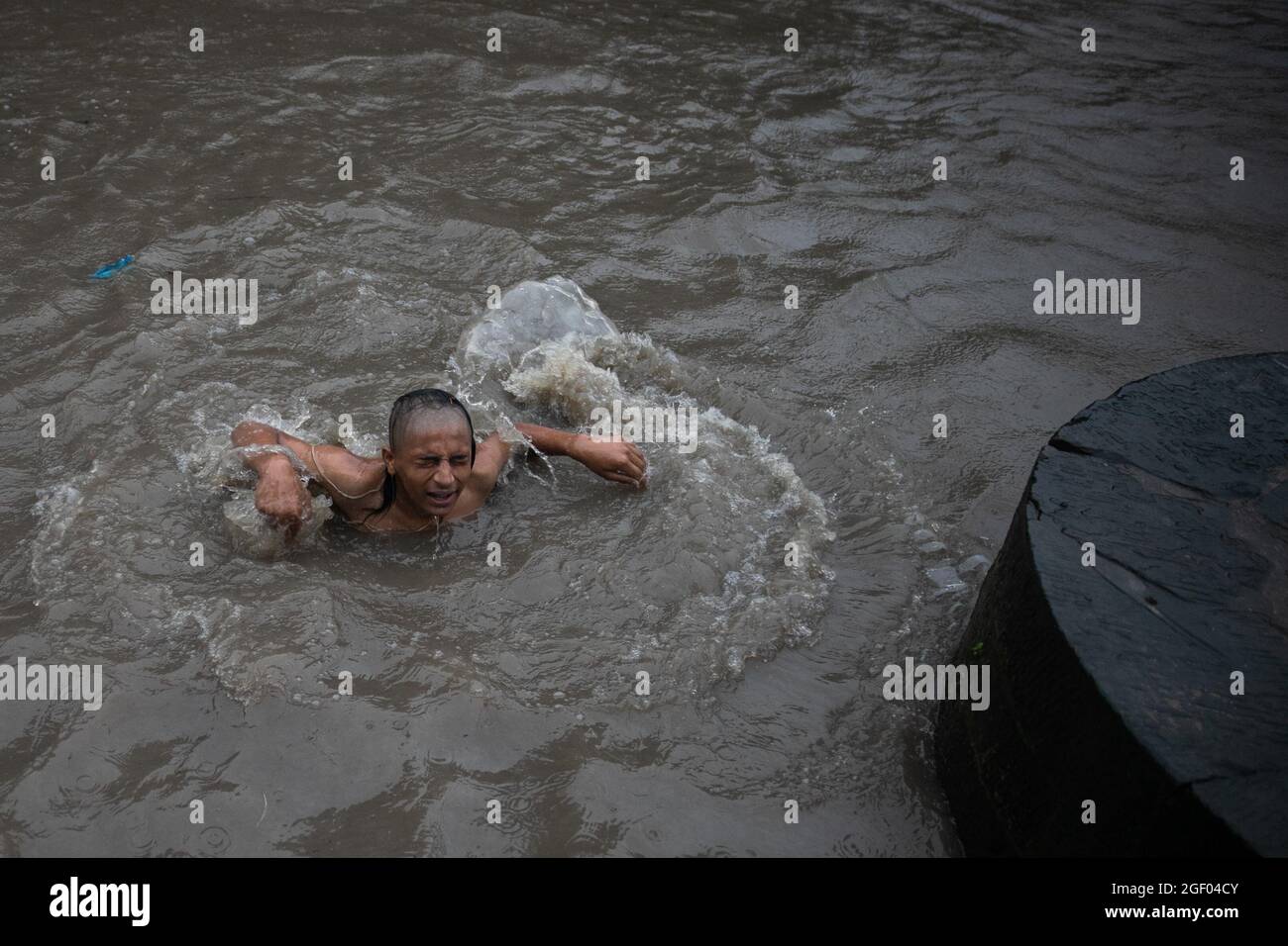 A Hindu priest takes a holy bath at Bagmati River.Janai Purnima also ...