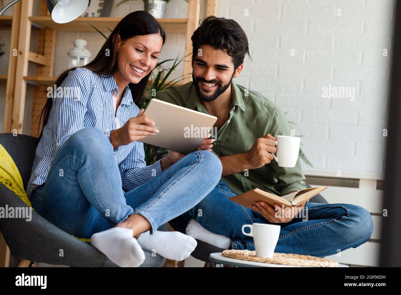 Close up portrait of an attractive married couple using digital tablet ...