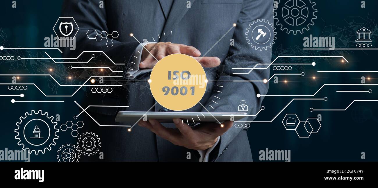 Businessman holding a tablet with the ISO 9001 icon. ISO standards ...