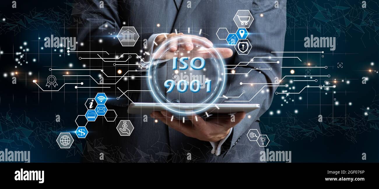 Businessman holding a tablet with the ISO 9001 icon. ISO standards ...