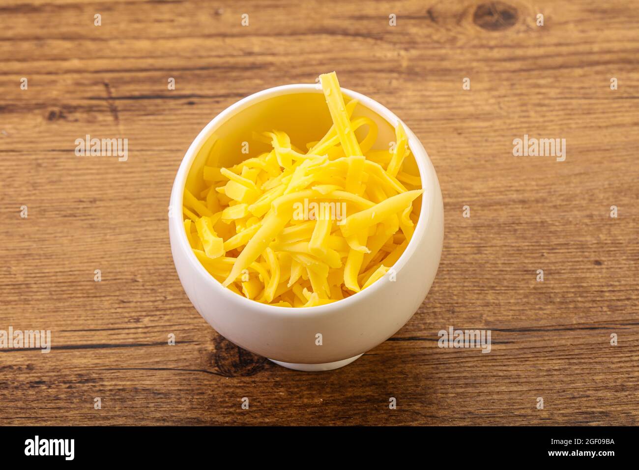 Shredded yellow cheese in the bowl for cooking Stock Photo - Alamy