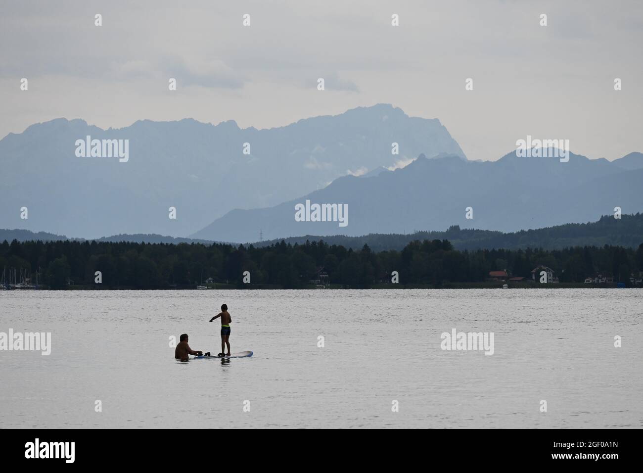 22 August 2021, Ambach am Starnberger See: People swimming in the ...