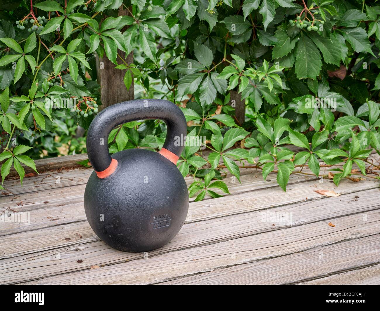 heavy iron competition kettlebell for weight training on wooden grunge ...