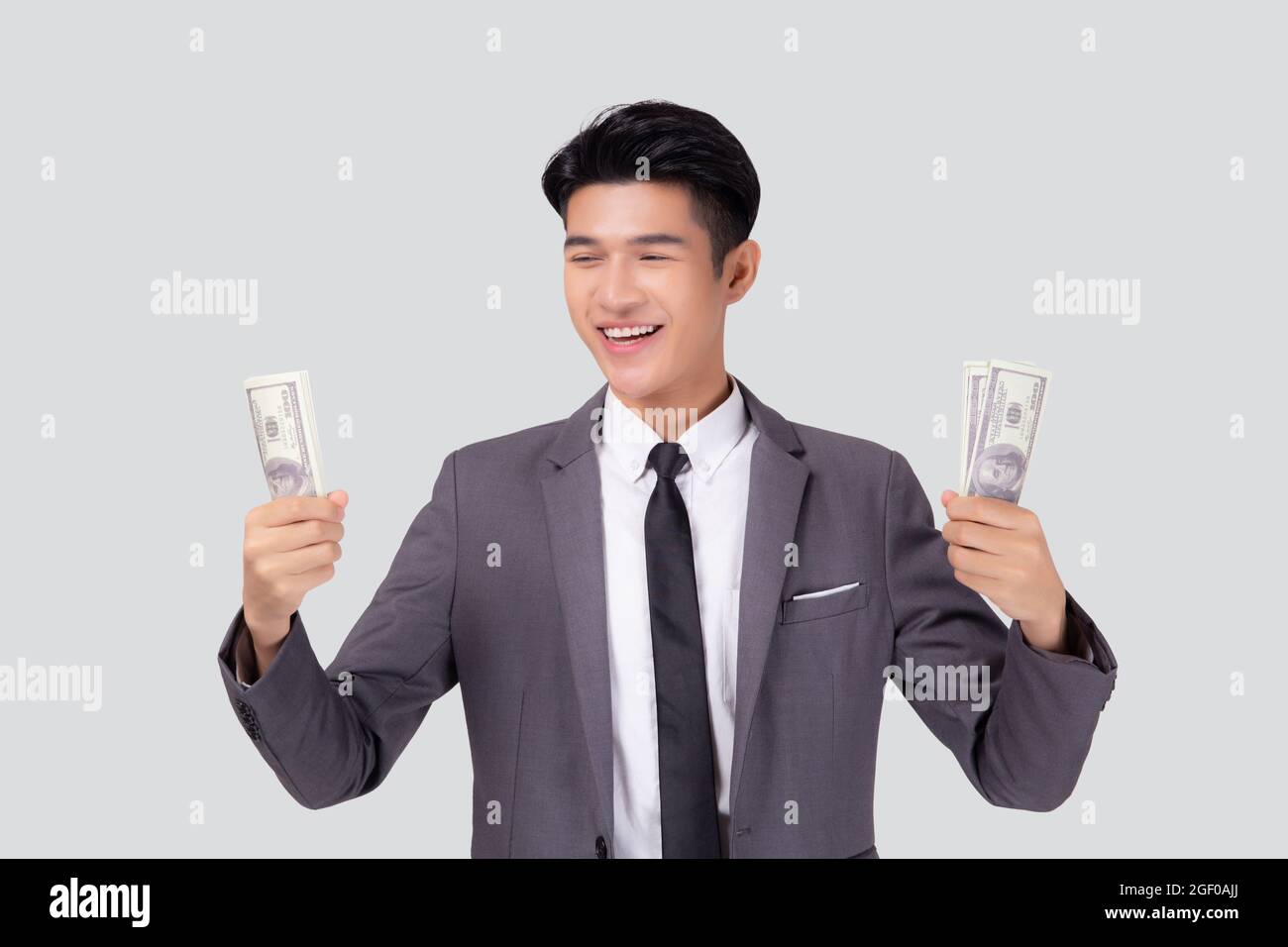 Young asian business man holding money dollar isolated on white ...