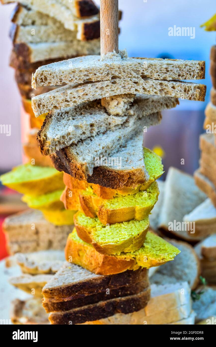 A closeup of the slices of fresh various bread stacked on each other ...