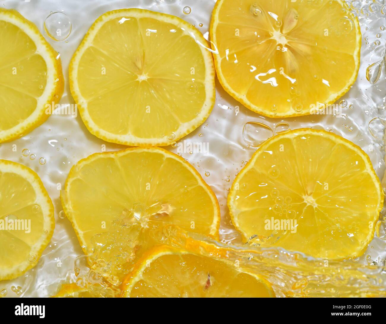 Close-up view of the yellow lemon slices in lemonade background ...
