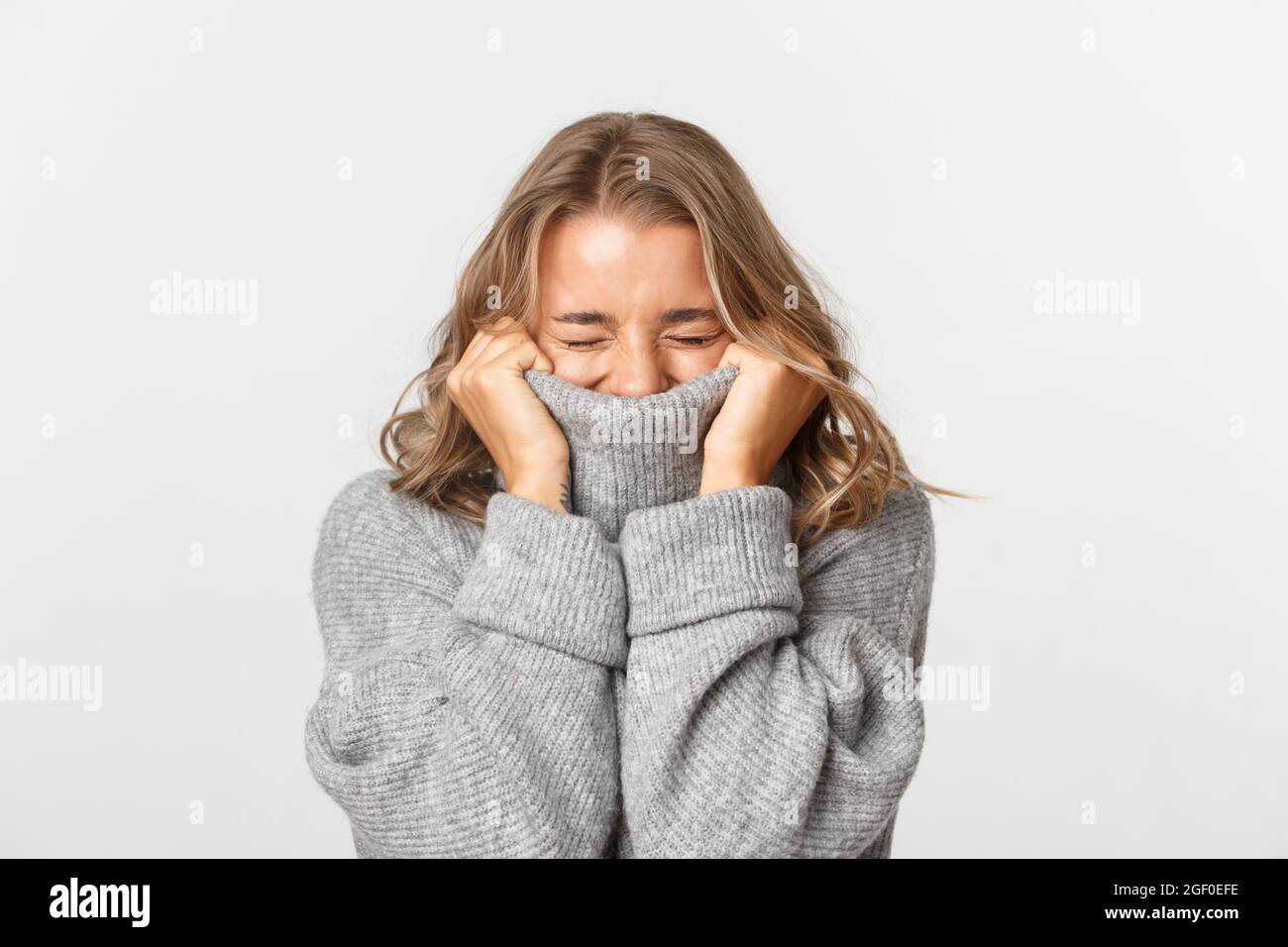 Woman pulling sweater over face hi-res stock photography and images - Alamy
