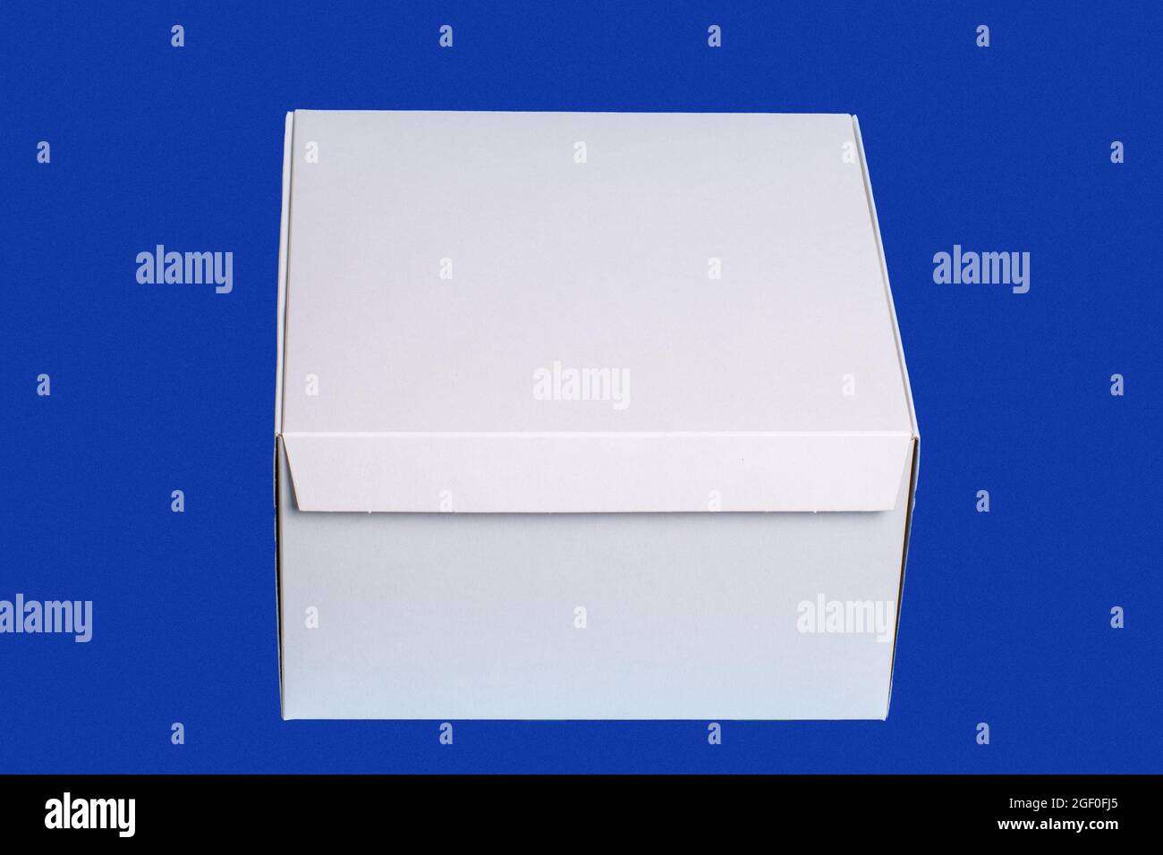 Close up photo of a white box without its shadow on a classic dark blue ...