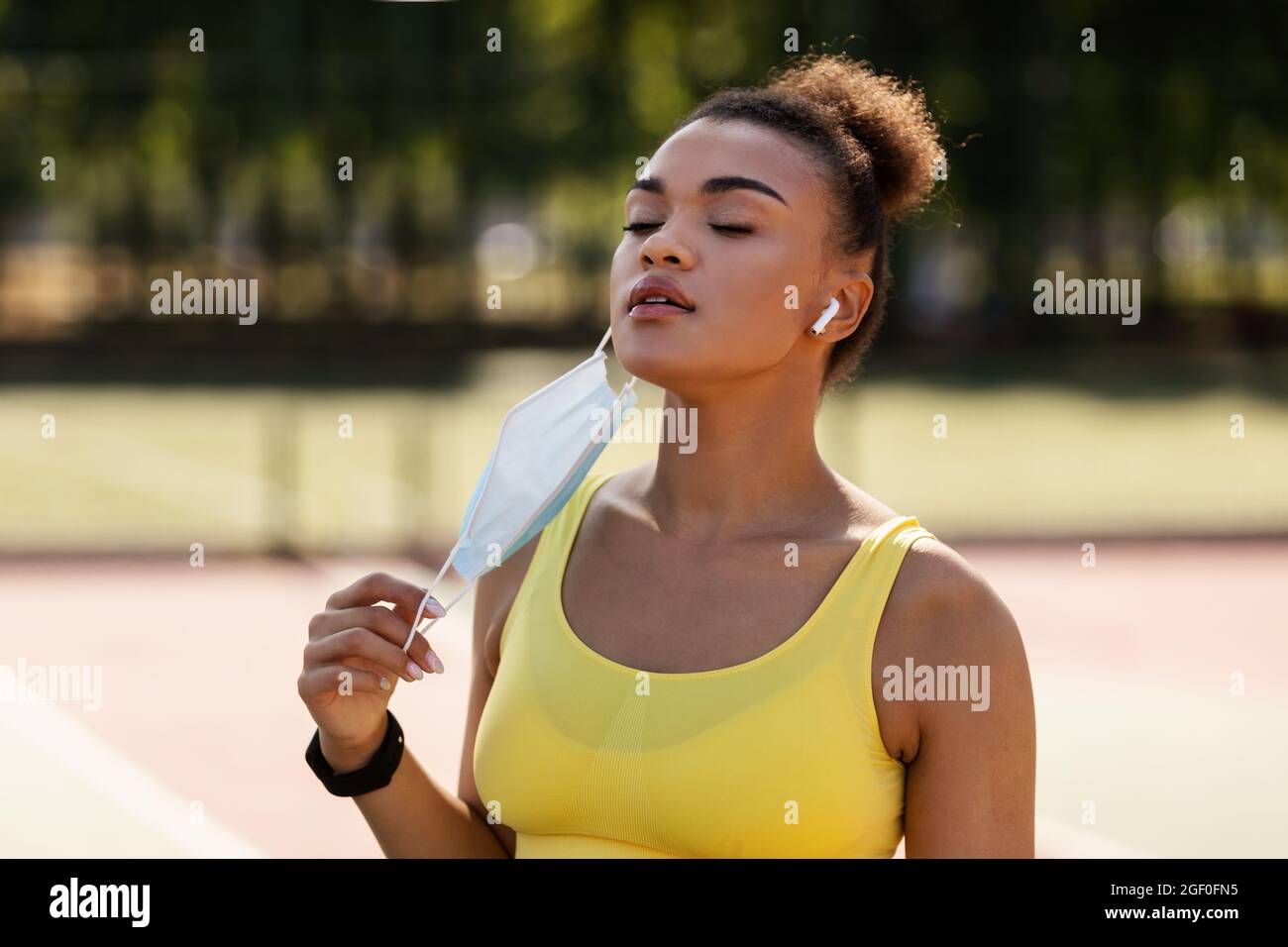 Woman taking off black female hi-res stock photography and images - Alamy