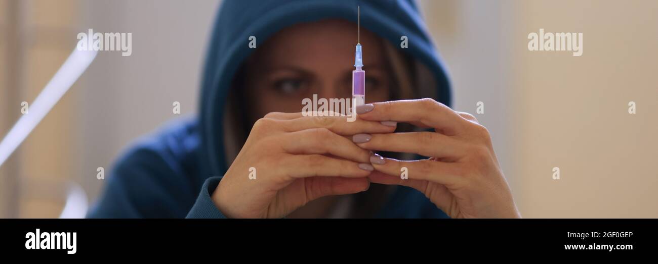 Woman drug addict sits on stairs with syringe Stock Photo - Alamy