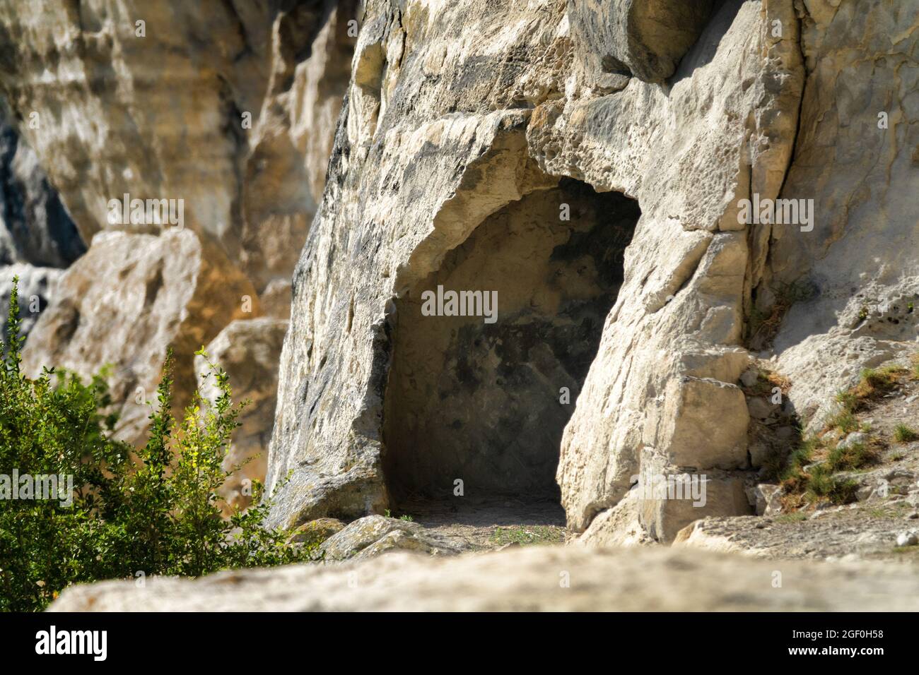 Entrance to a man-made cave in a limestone rock. A place of refuge for ...