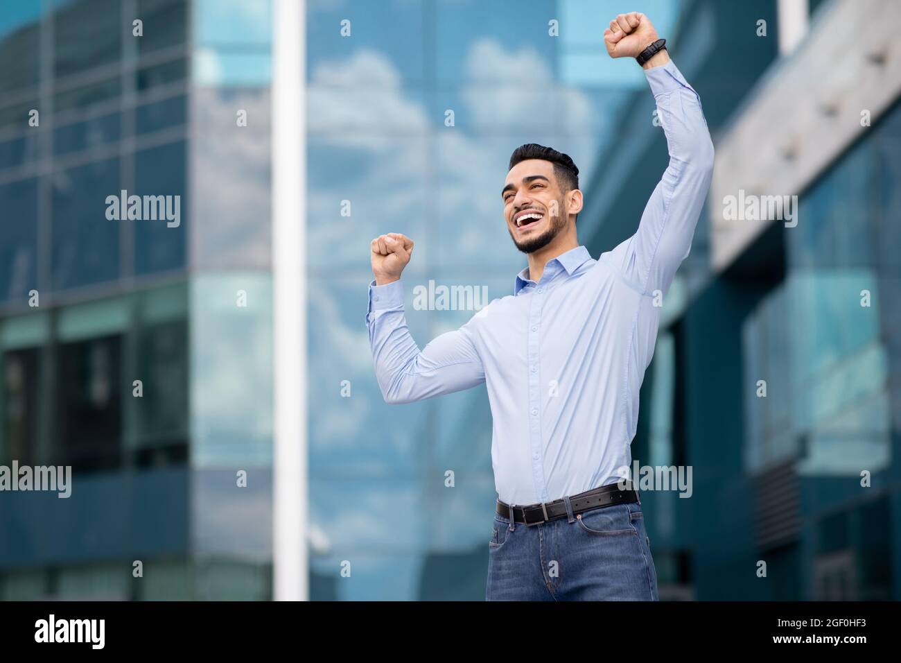 Man in suit raising hands hi-res stock photography and images - Alamy