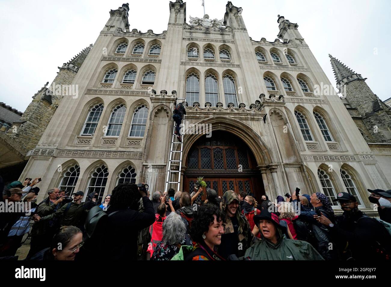 A man climbs a ladder as members of Extinction Rebellion stage a ...