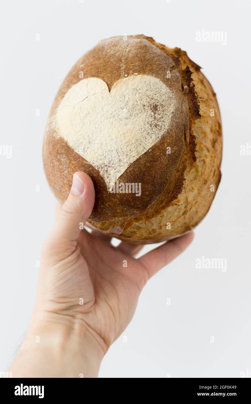Artisan bread in hand on white background Stock Photo - Alamy