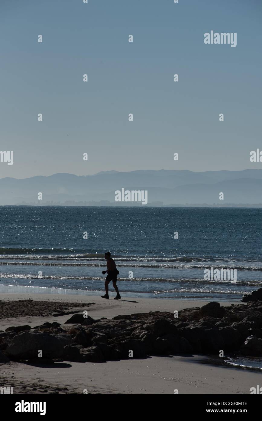Lonely figure of sea fisherman hi-res stock photography and images - Alamy