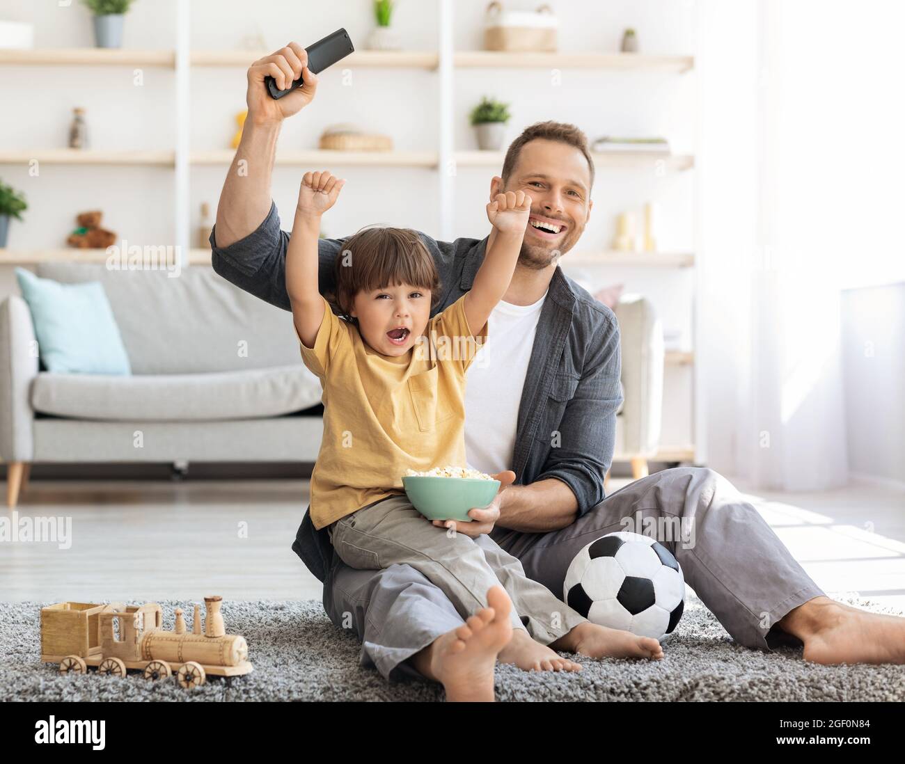 Emotional little boy cheering for favorite soccer team, watching sports ...