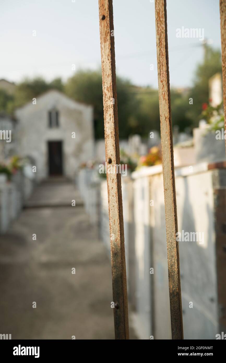 Quiet and old country cemetery with small church in the background ...