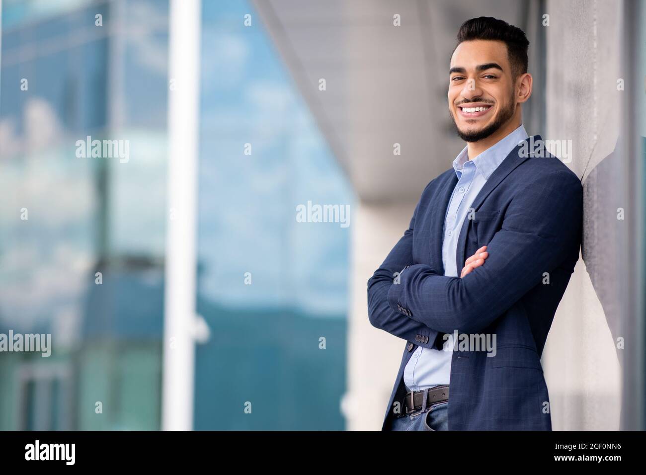 Cheerful handsome arab man manager posing by business center Stock ...