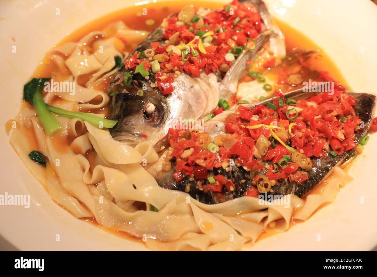 Chilli fish head and hands to hammer Stock Photo - Alamy
