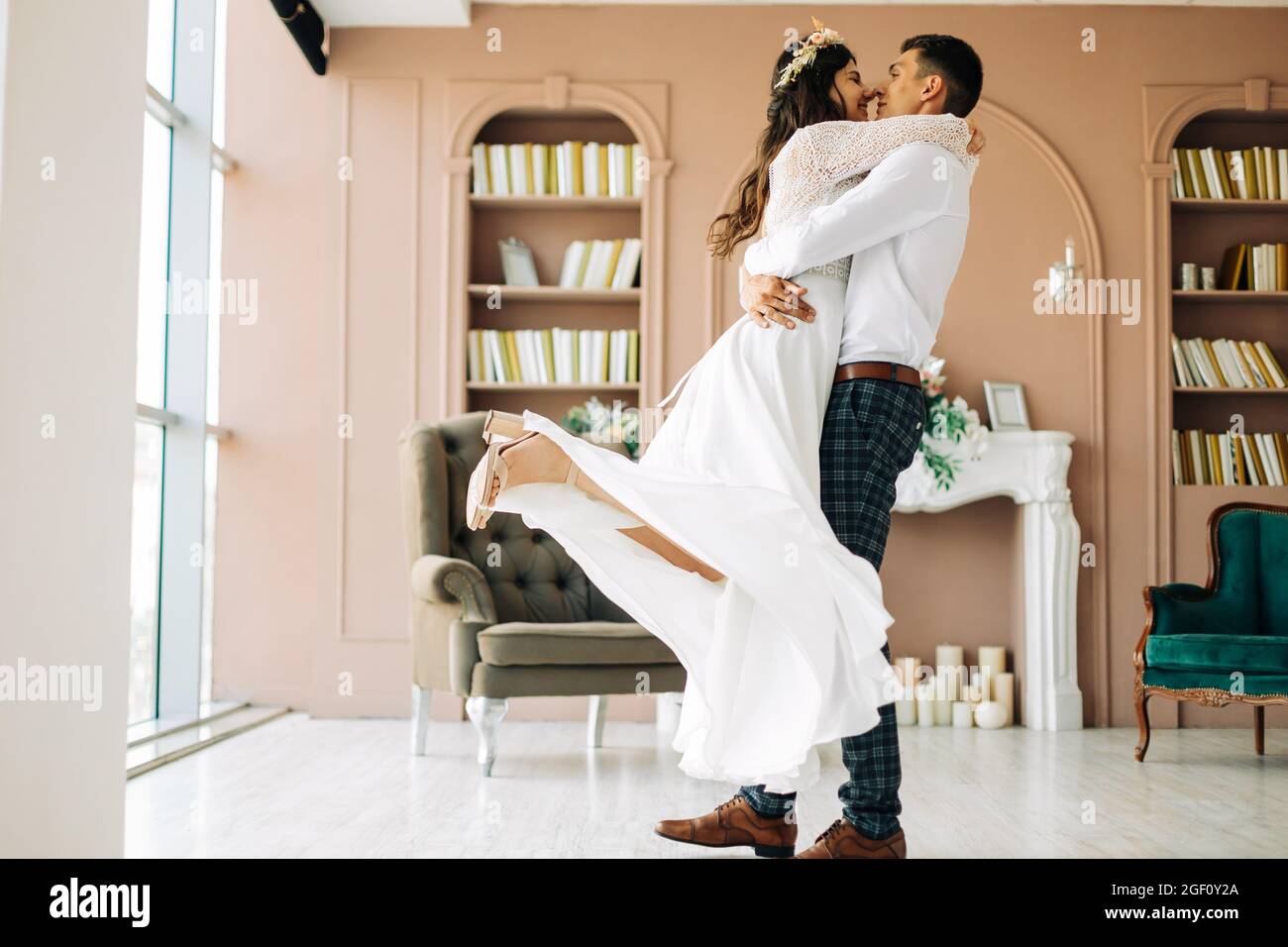 Happy wedding couple, attractive bride and groom hug each other, the ...