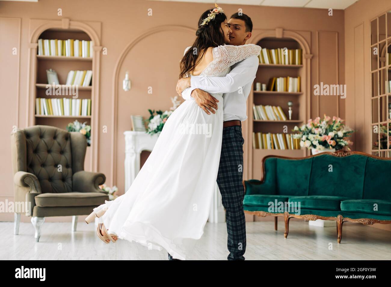 Happy wedding couple, attractive bride and groom hug each other, the ...