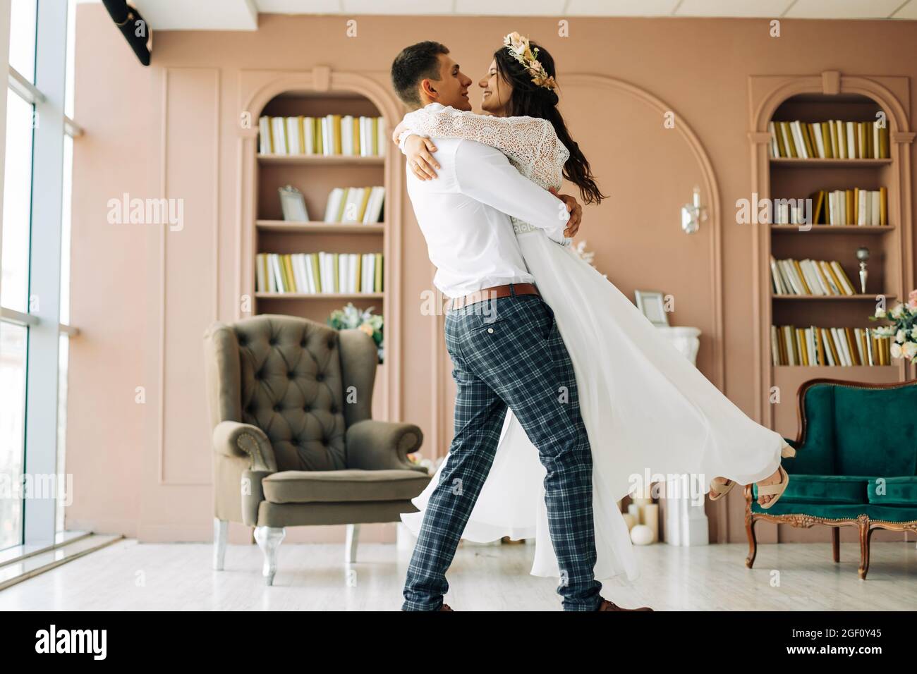 Happy wedding couple, attractive bride and groom hug each other, the ...